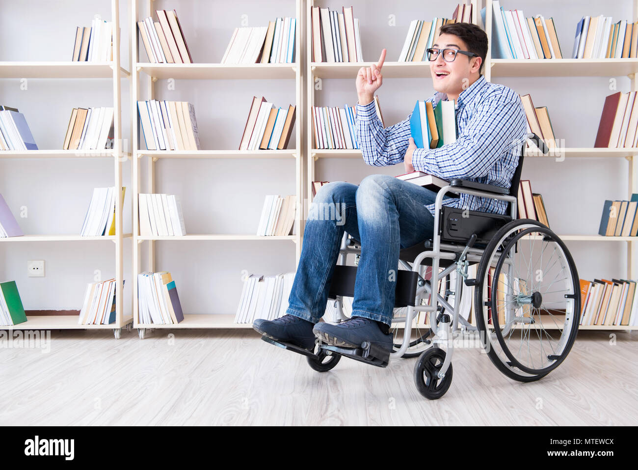 Disabled student studying in the library Stock Photo - Alamy