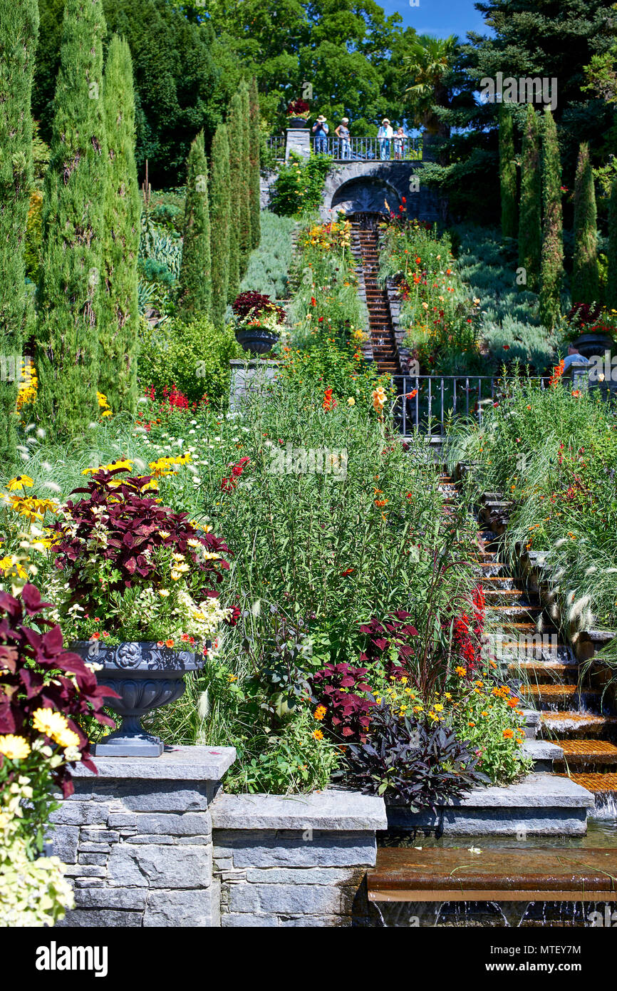 Mainau gardens - water feature (waterfall) lined by flowers and trees ...