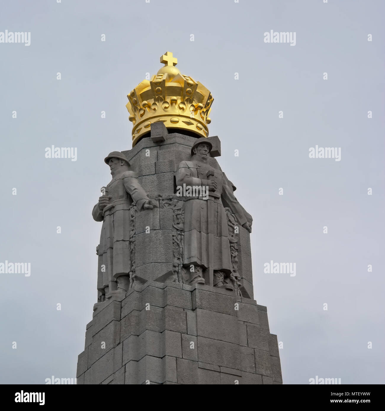 Stone statues of soldiers with golden crown on top, detail of the ...
