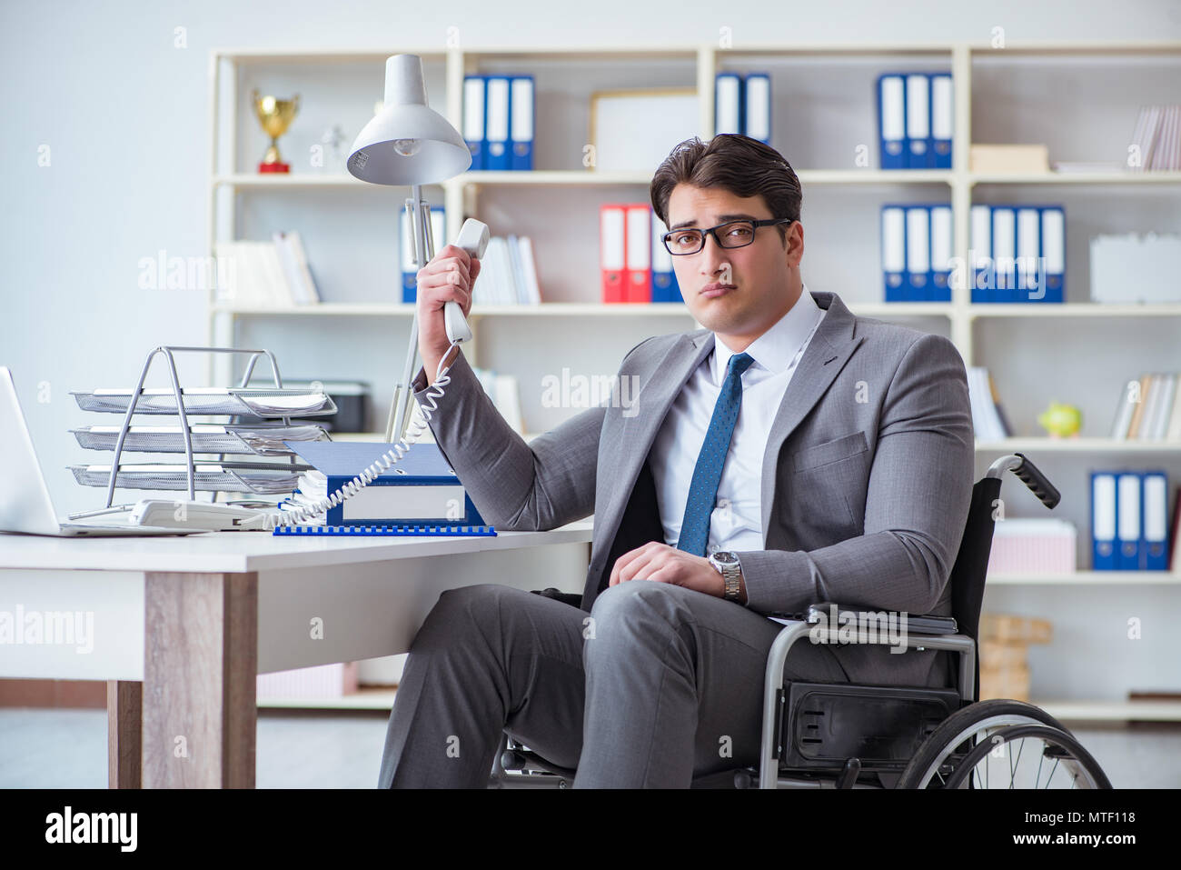 Disabled businessman working in the office Stock Photo - Alamy