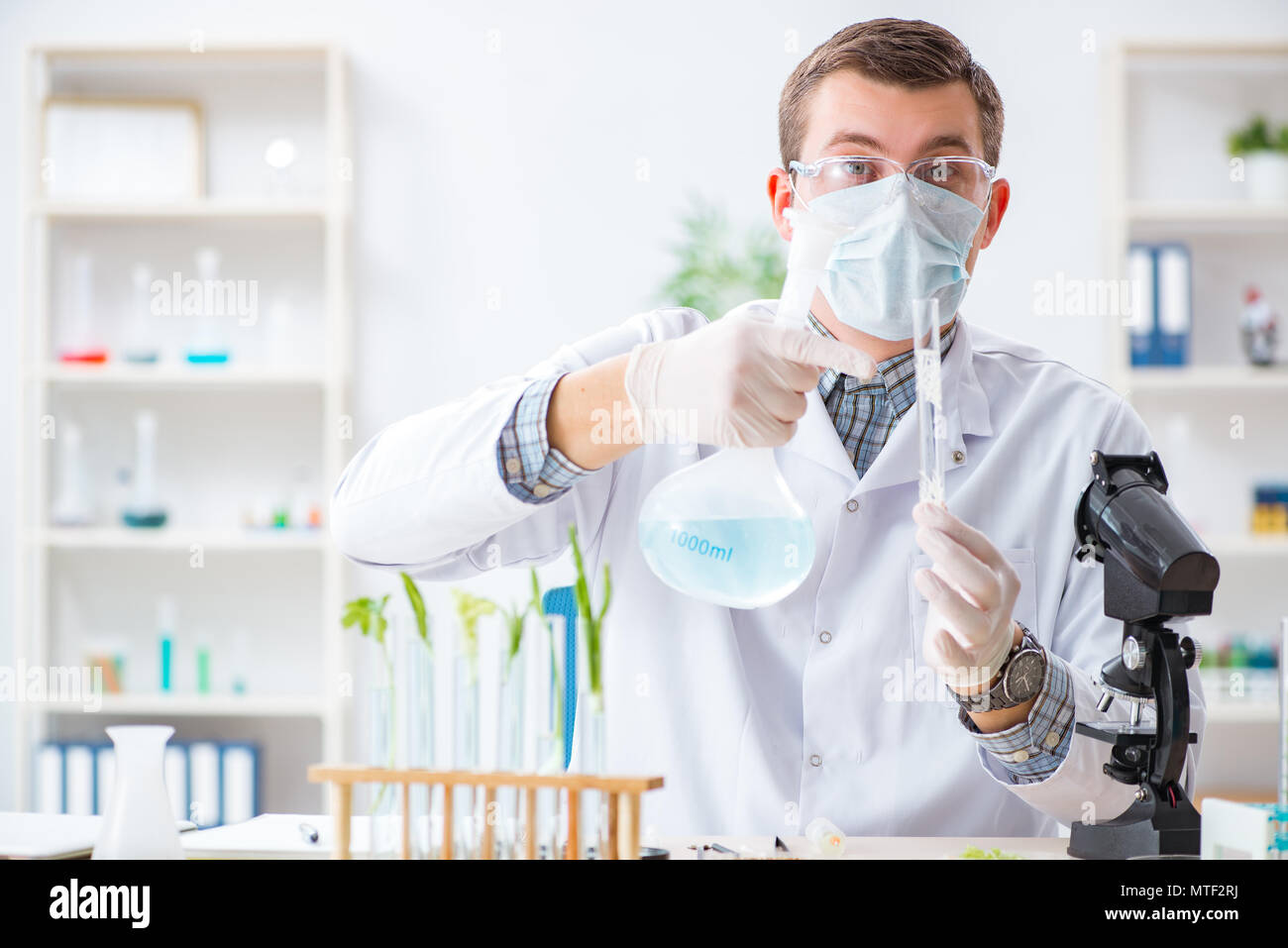 Male biochemist working in the lab on plants Stock Photo - Alamy