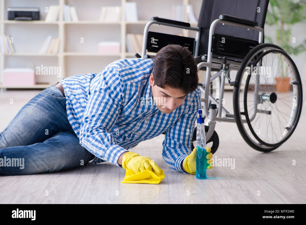 Disabled man on wheelchair cleaning home Stock Photo - Alamy
