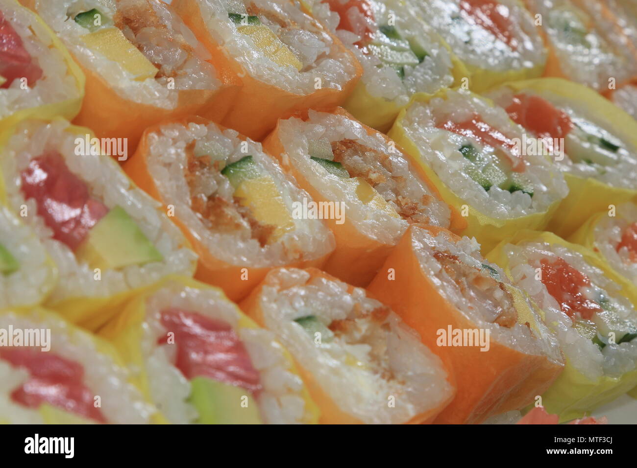 Yellow and orange sushi rolls Stock Photo - Alamy