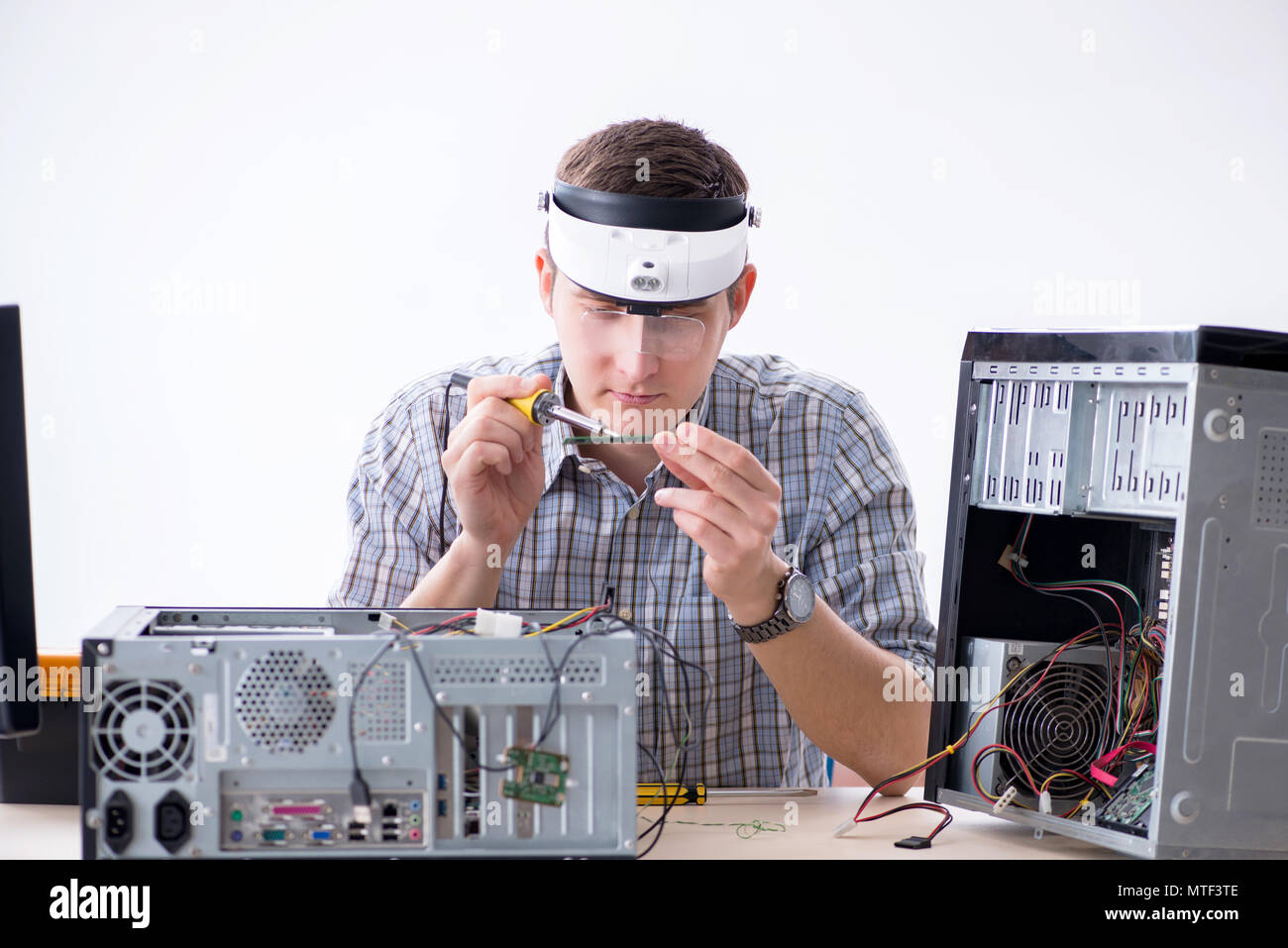Technician examining motherboard magnifying hi-res stock photography ...