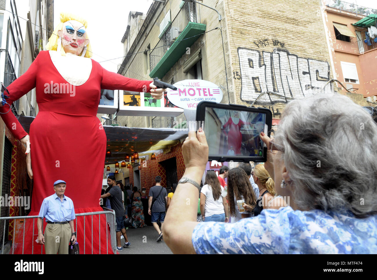 OLD LADY TAKING A PICTURE WITH HER TABLET STREETS DECORATED DURING ...