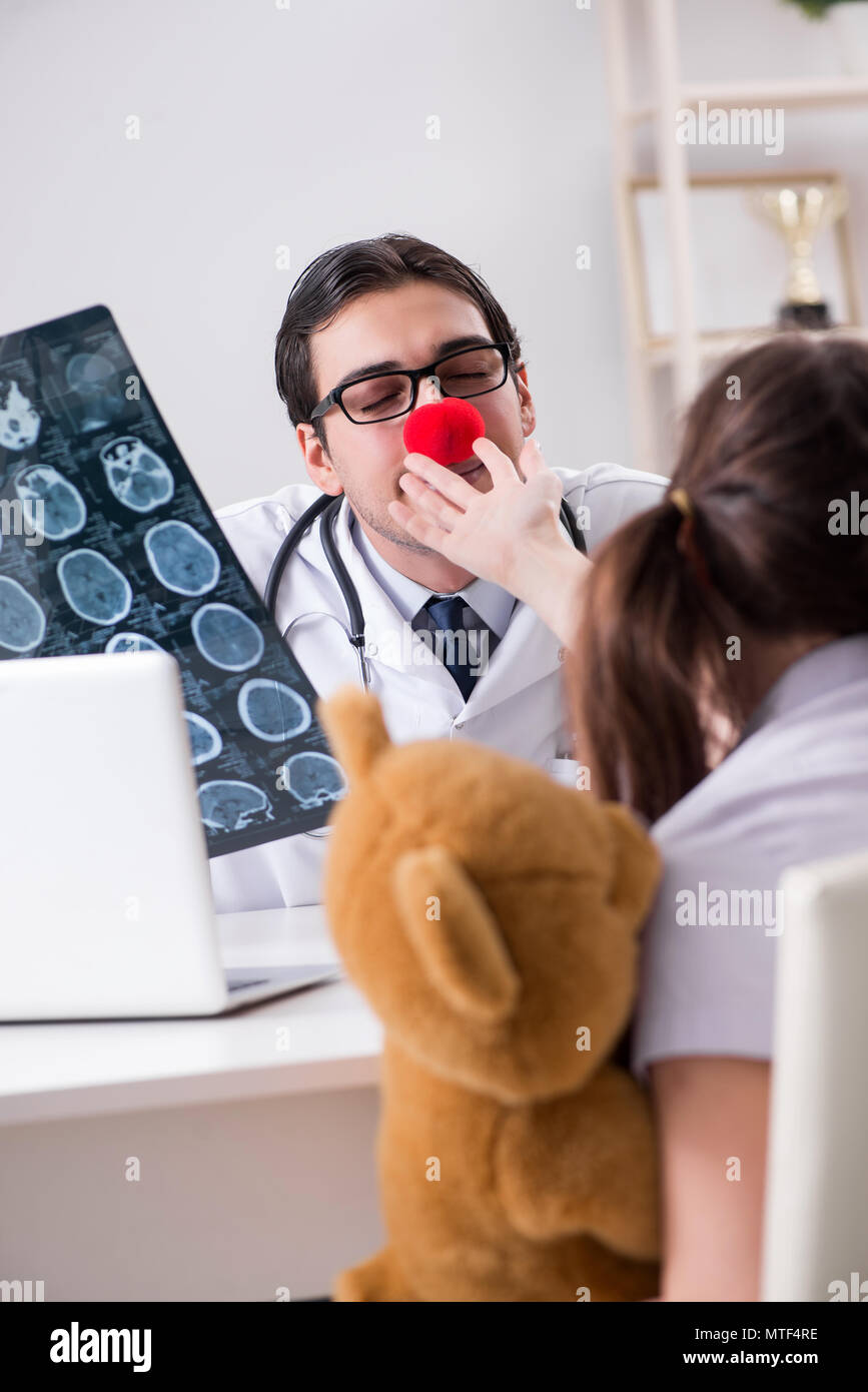 Funny pediatrician with little girl at regular check-up Stock Photo - Alamy