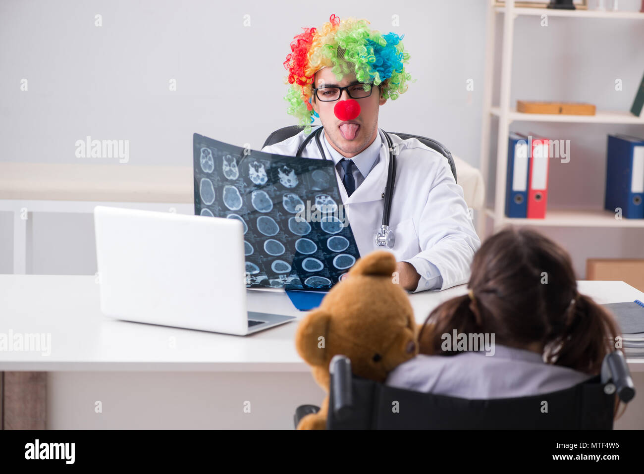 Funny pediatrician with little girl at regular check-up Stock Photo - Alamy