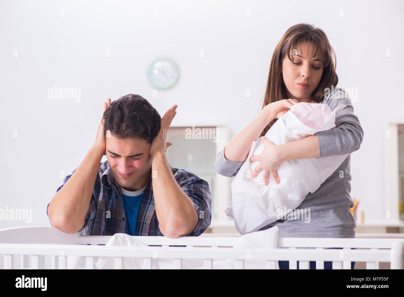 Young dad cannot stand baby crying Stock Photo - Alamy