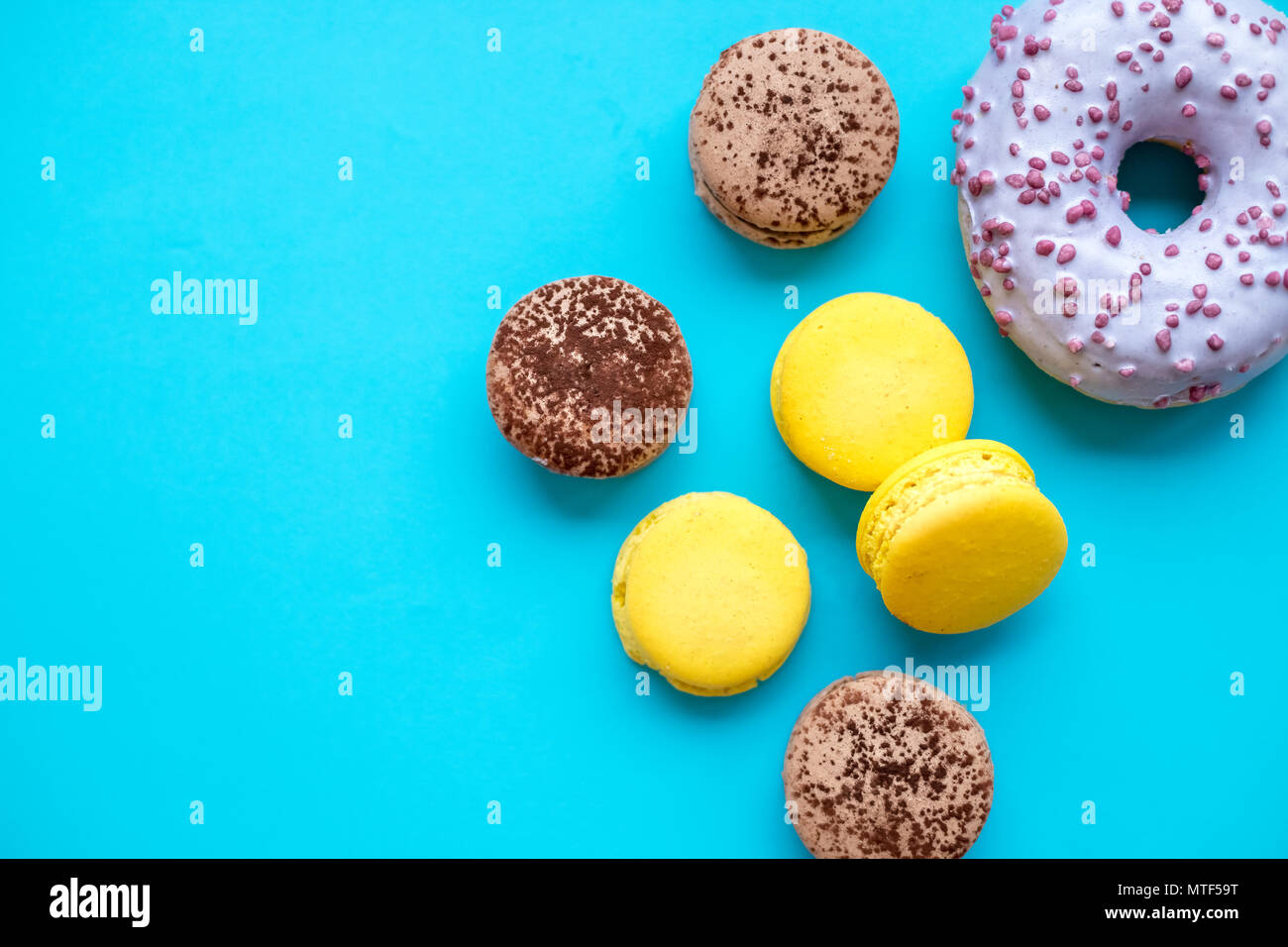 Different types of macaroons, donuts on blue candy background.Colorful ...