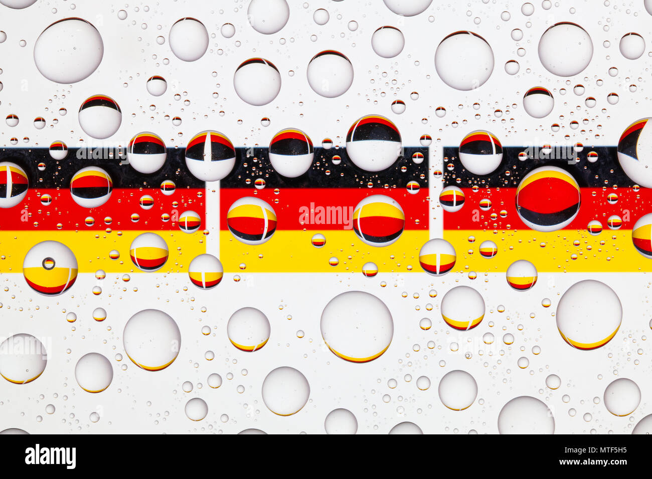 Flags of Germany behind a glass covered with raindrops Stock Photo - Alamy