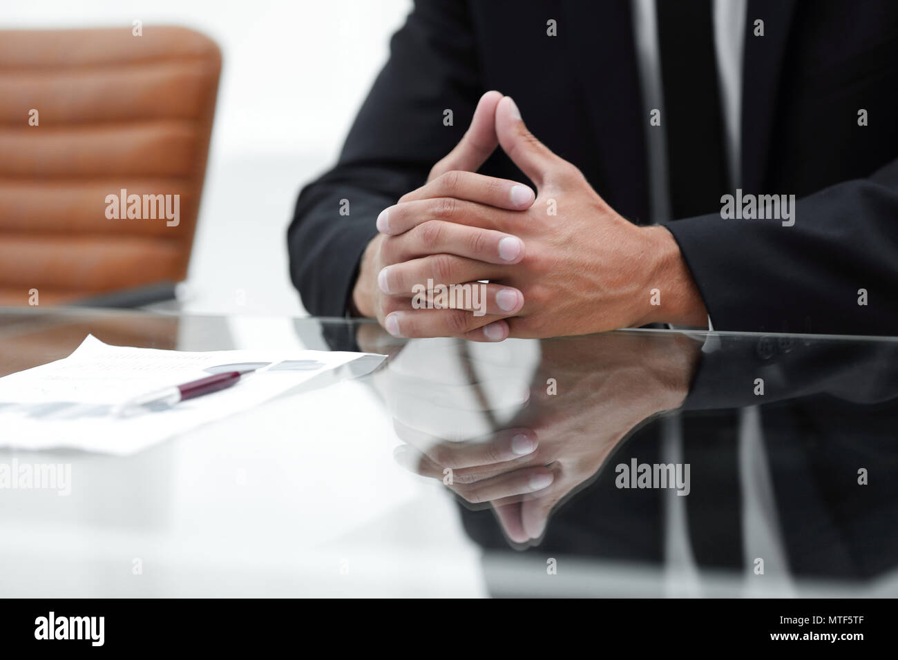 closeup.business man sitting behind a Desk Stock Photo - Alamy