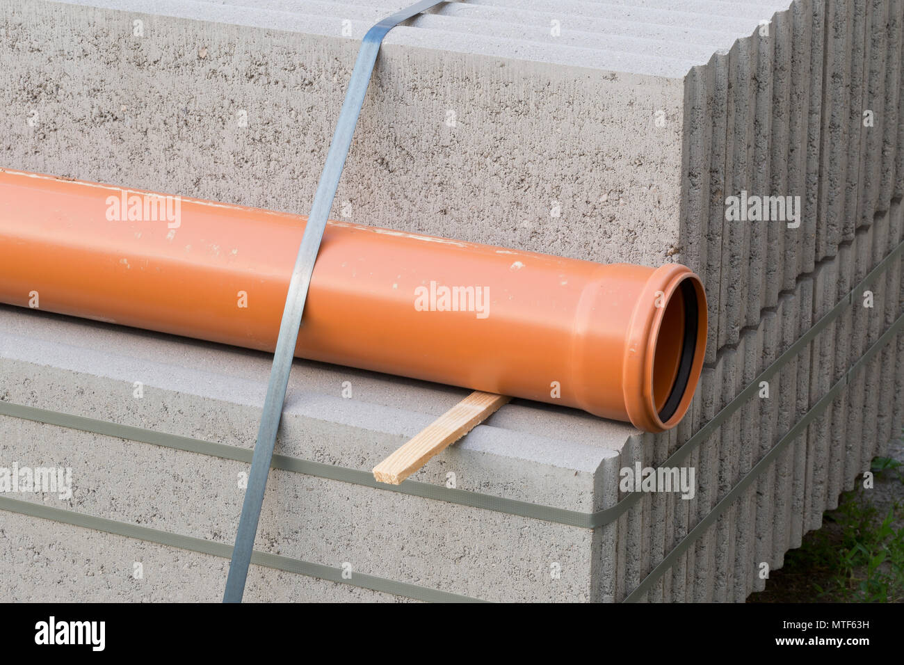 Concrete blocks and plastic pvc sewage pipe on palette on building ...