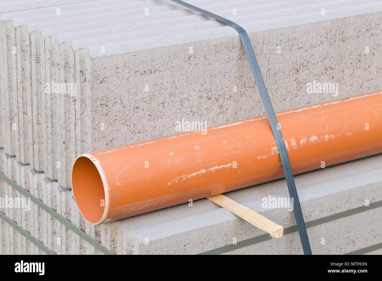 Concrete blocks and plastic pvc sewage pipe on palette on building ...