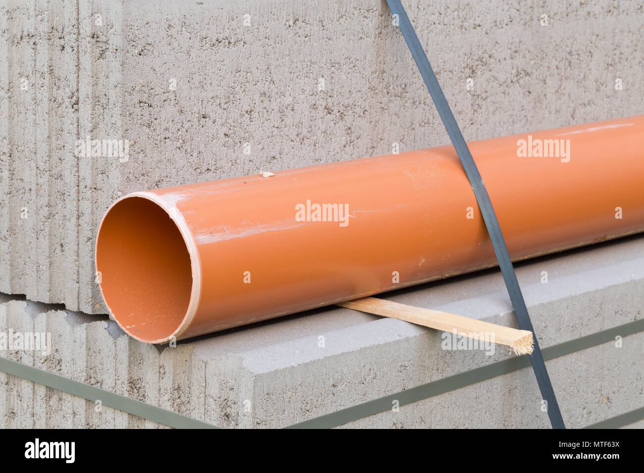 Concrete blocks and plastic pvc sewage pipe on palette on building ...