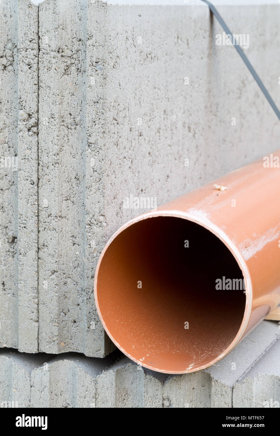 Concrete blocks and plastic pvc sewage pipe on palette on building ...