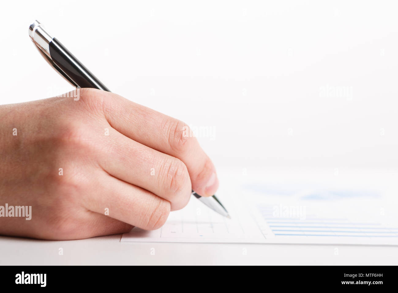 Business people use pen to point graphs to analyze company data and ...