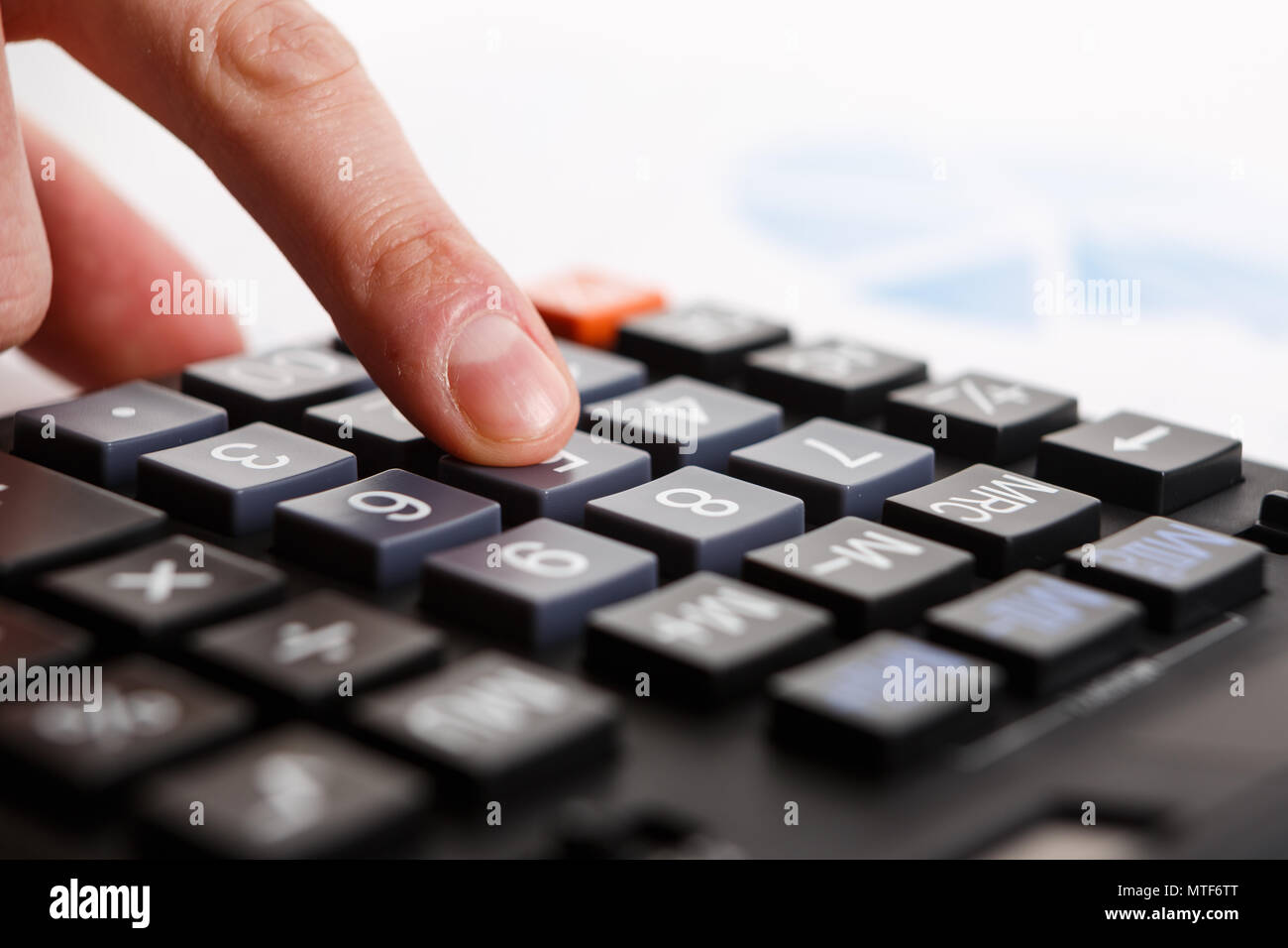 Business people who use a calculator with financial concepts Stock ...