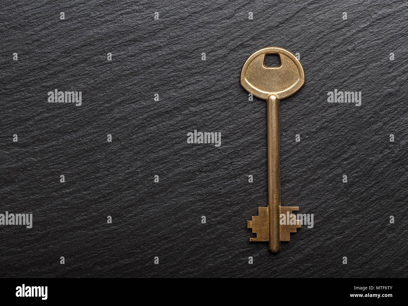 Golden metal key on a black background, horizontal photo Stock Photo ...