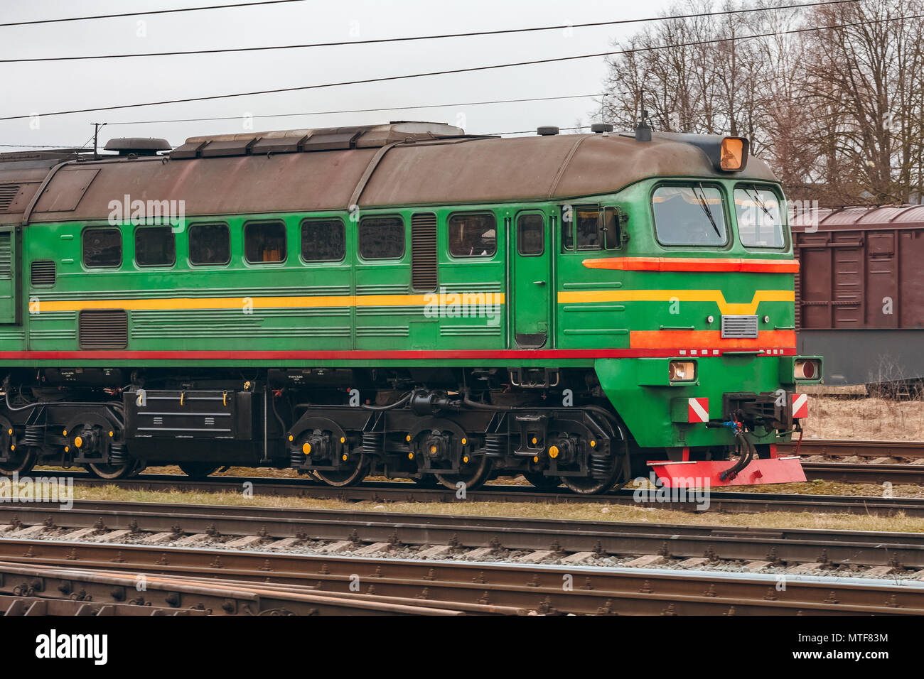 Green diesel cargo locomotive. Freight train in action Stock Photo - Alamy