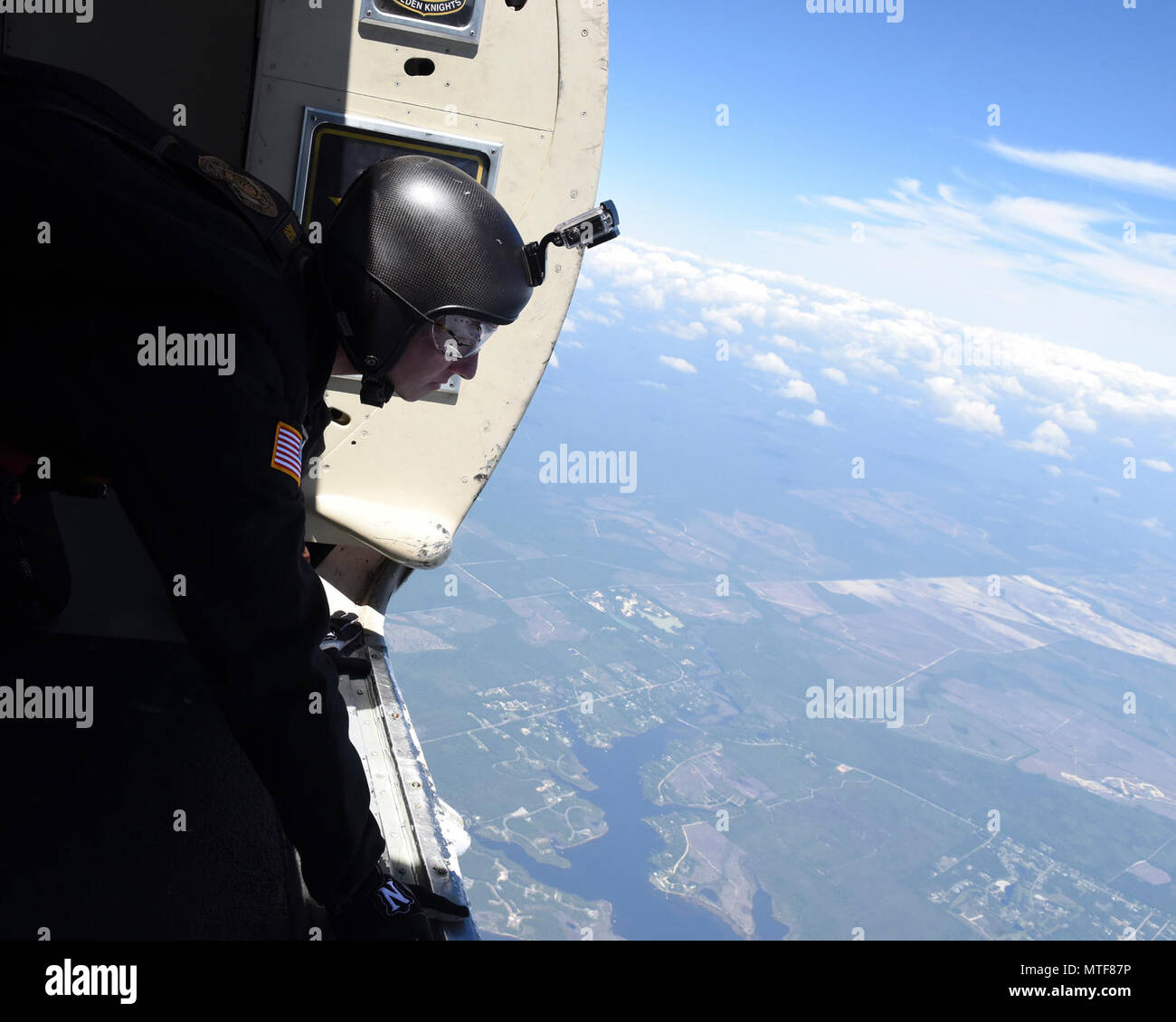 A U.S. Army Golden Knights skydive team member observes the ground ...
