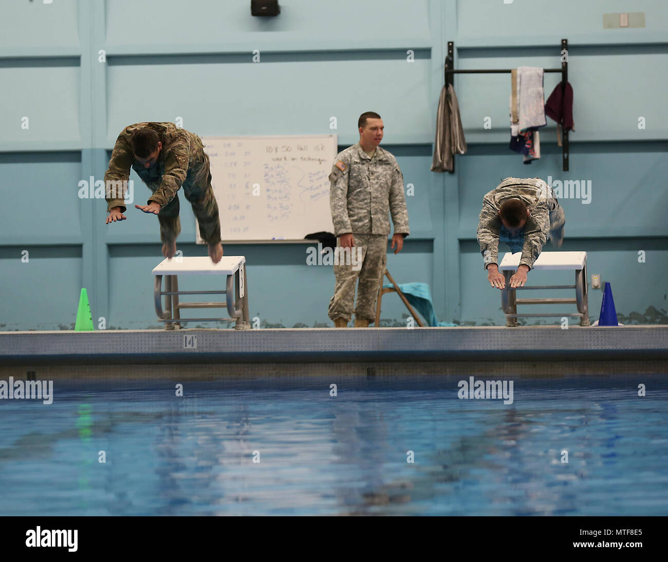 U.S. Soldiers with the 20th CBRNE Command, dive into the pool to ...