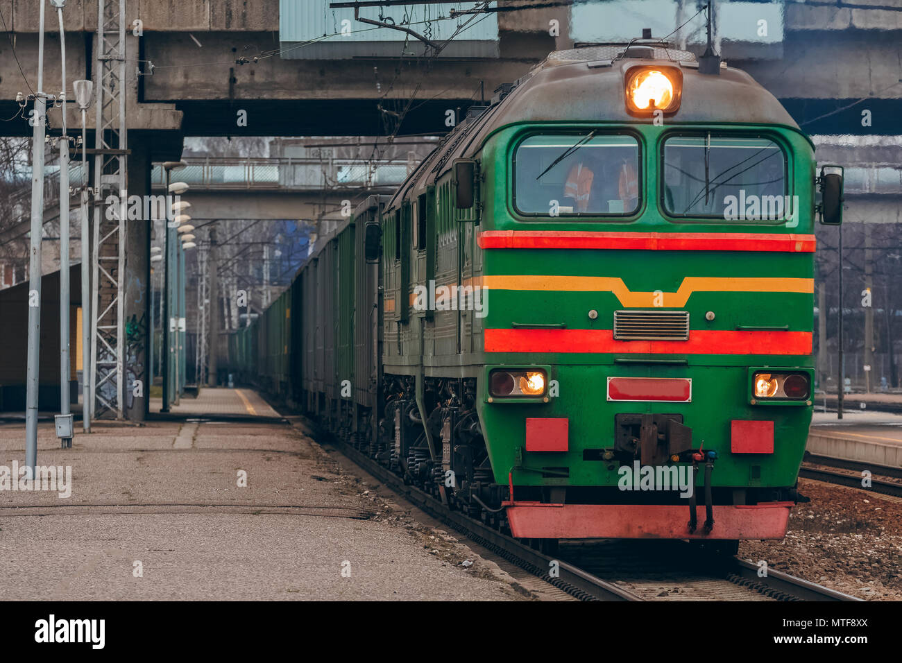 Green diesel cargo locomotive. Freight train in action Stock Photo - Alamy
