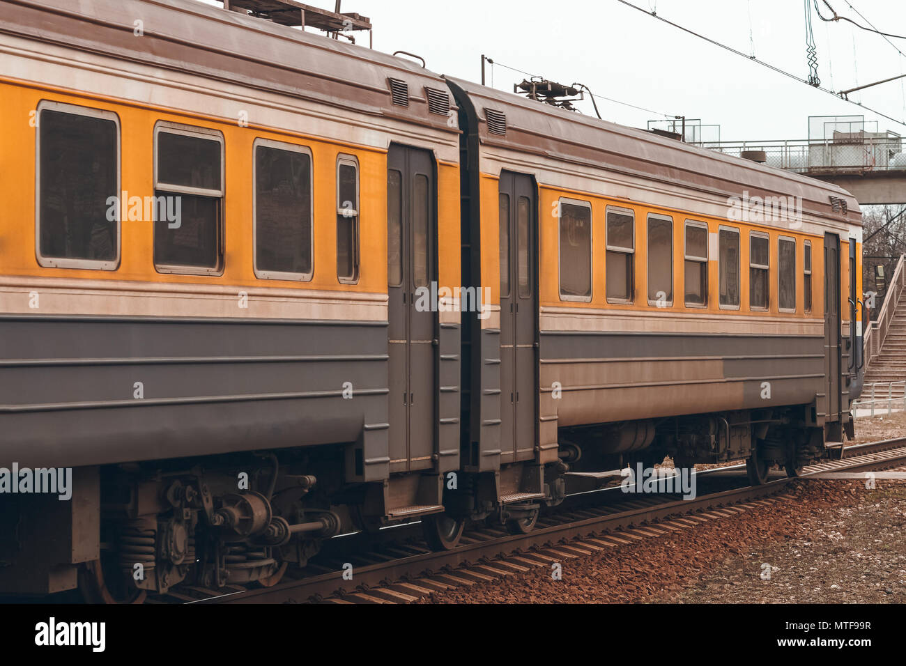 Old yellow passenger electric train driving at the terminal Stock Photo ...