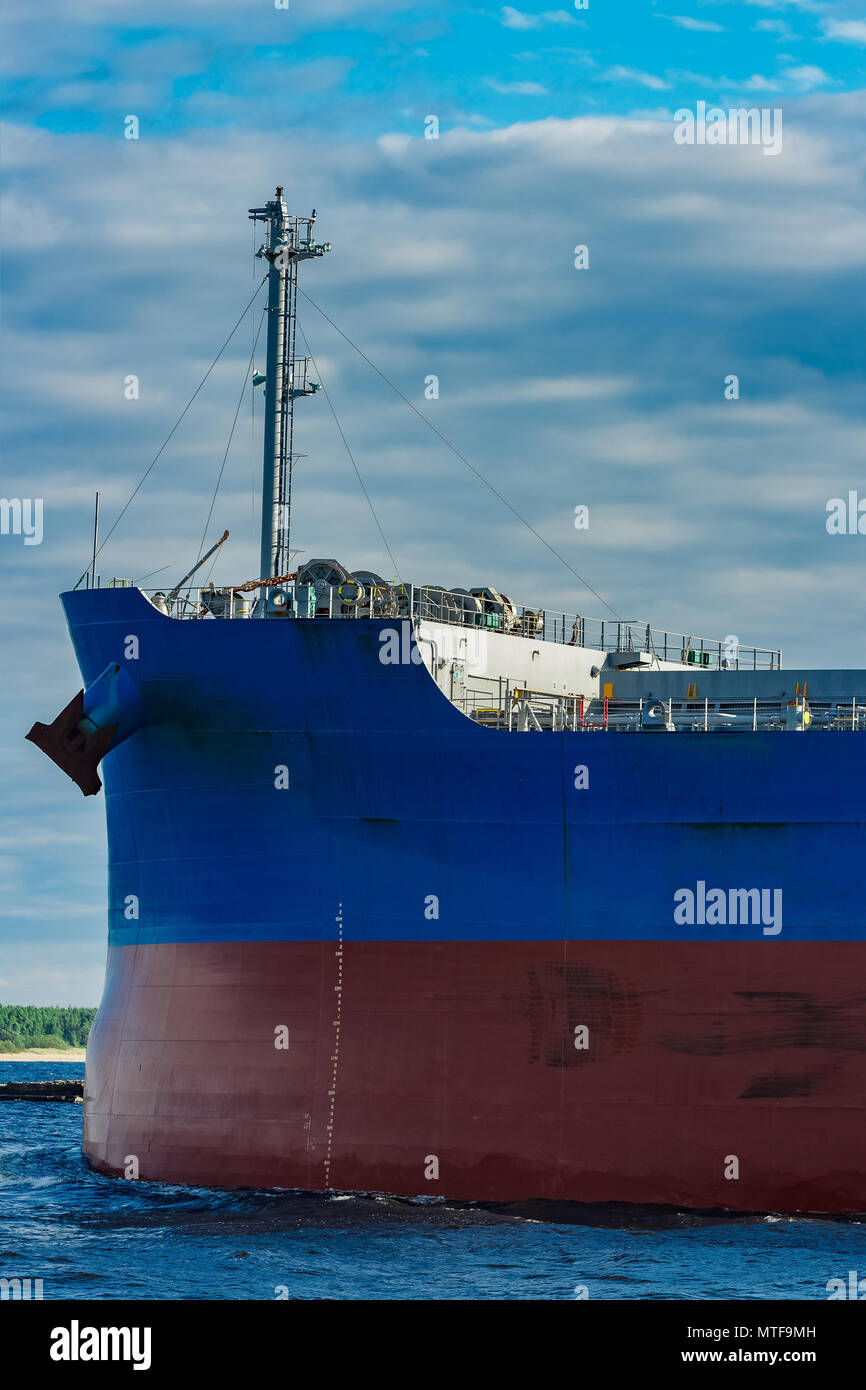Merchandise import. Large blue cargo ship moving to Riga port Stock ...