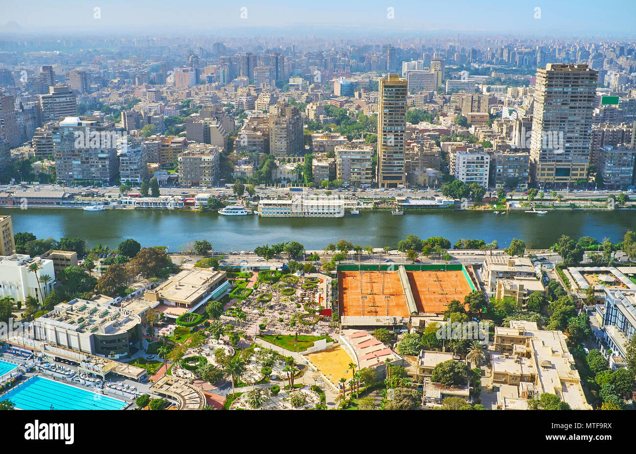 The skyline of Giza from the top of Cairo Tower with ornamental green ...