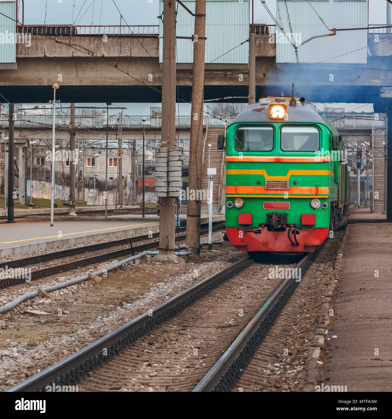 Green diesel cargo locomotive. Freight train in action Stock Photo - Alamy