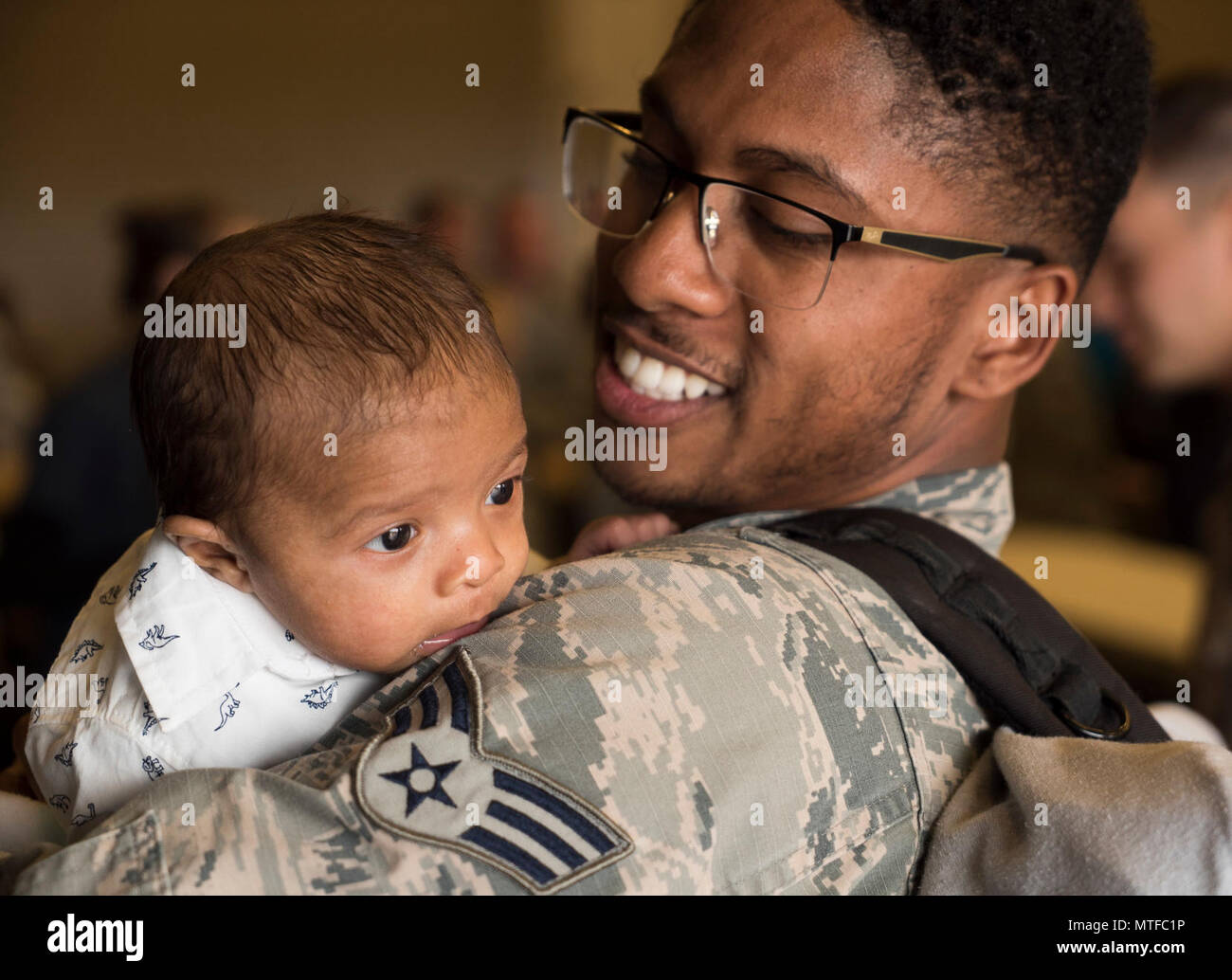 Senior Airman Aaron Wilson, holds his son, Adrian, for the first time ...