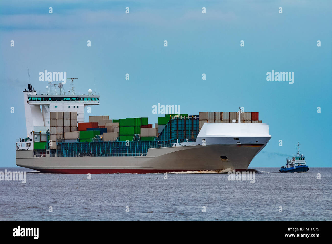 Grey container ship. Logistics and production import Stock Photo - Alamy