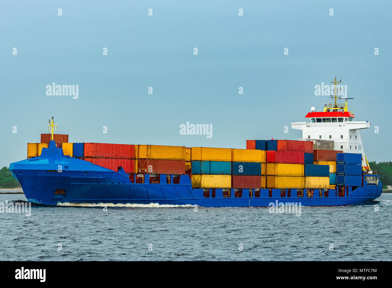 Blue cargo container ship fully loaded underway Stock Photo - Alamy