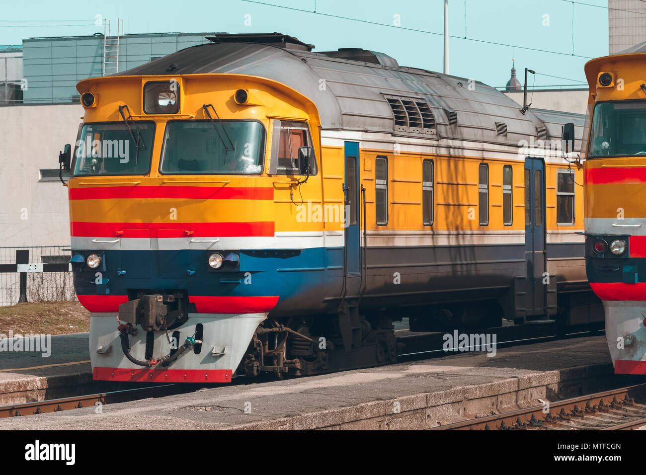 Old yellow passenger diesel train moving at the terminal Stock Photo ...