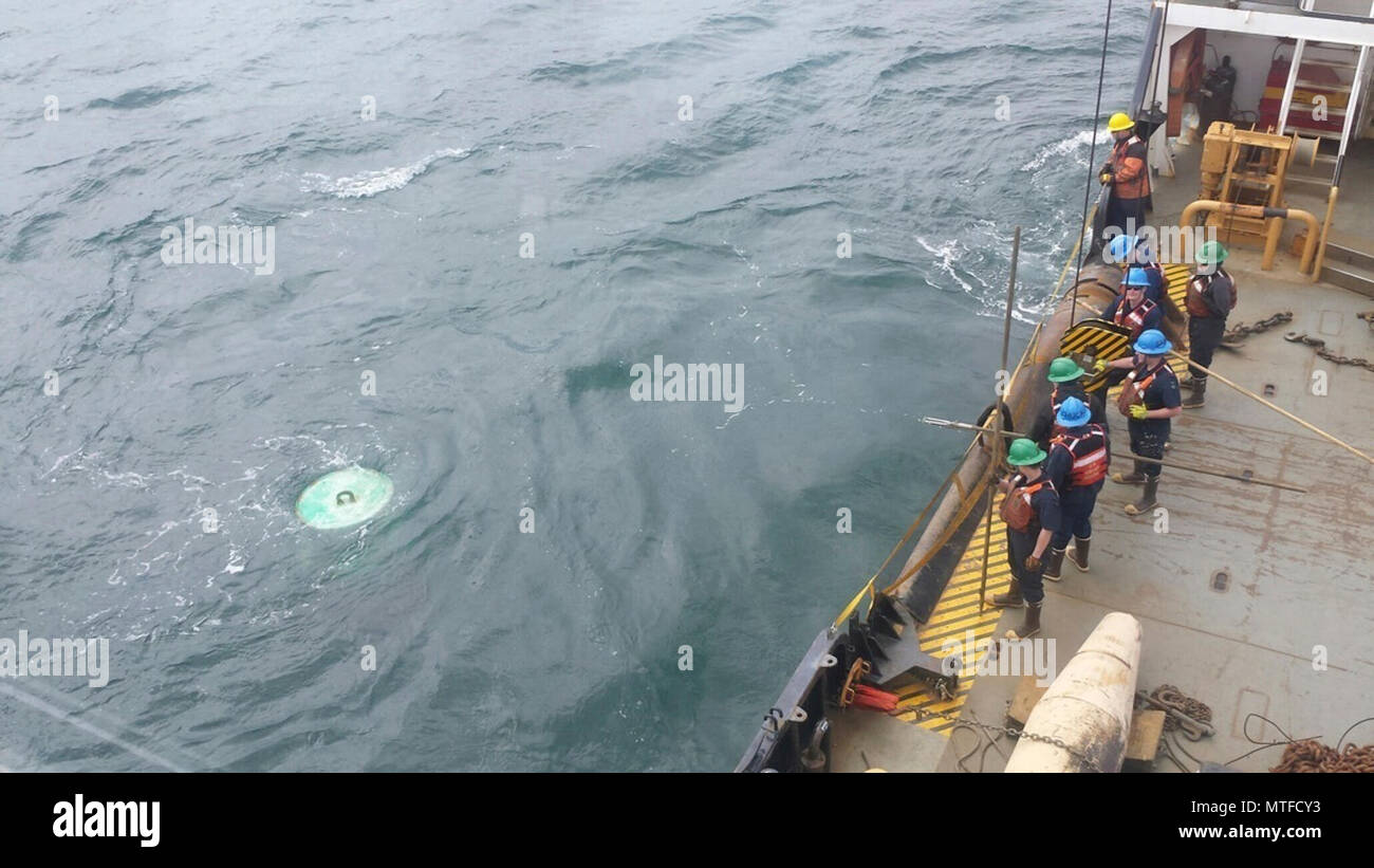 The crew of Coast Guard Cutter Ida Lewis observe a submerged buoy in ...