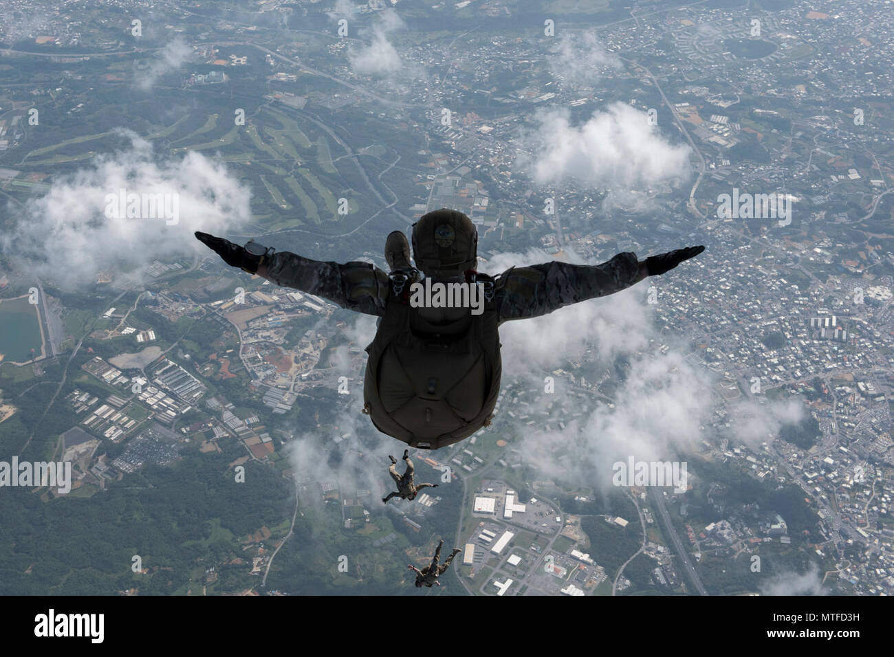 U.S. Air Force Airmen and U.S. Army Soldiers perform a high altitude, low opening jump off an MC ...