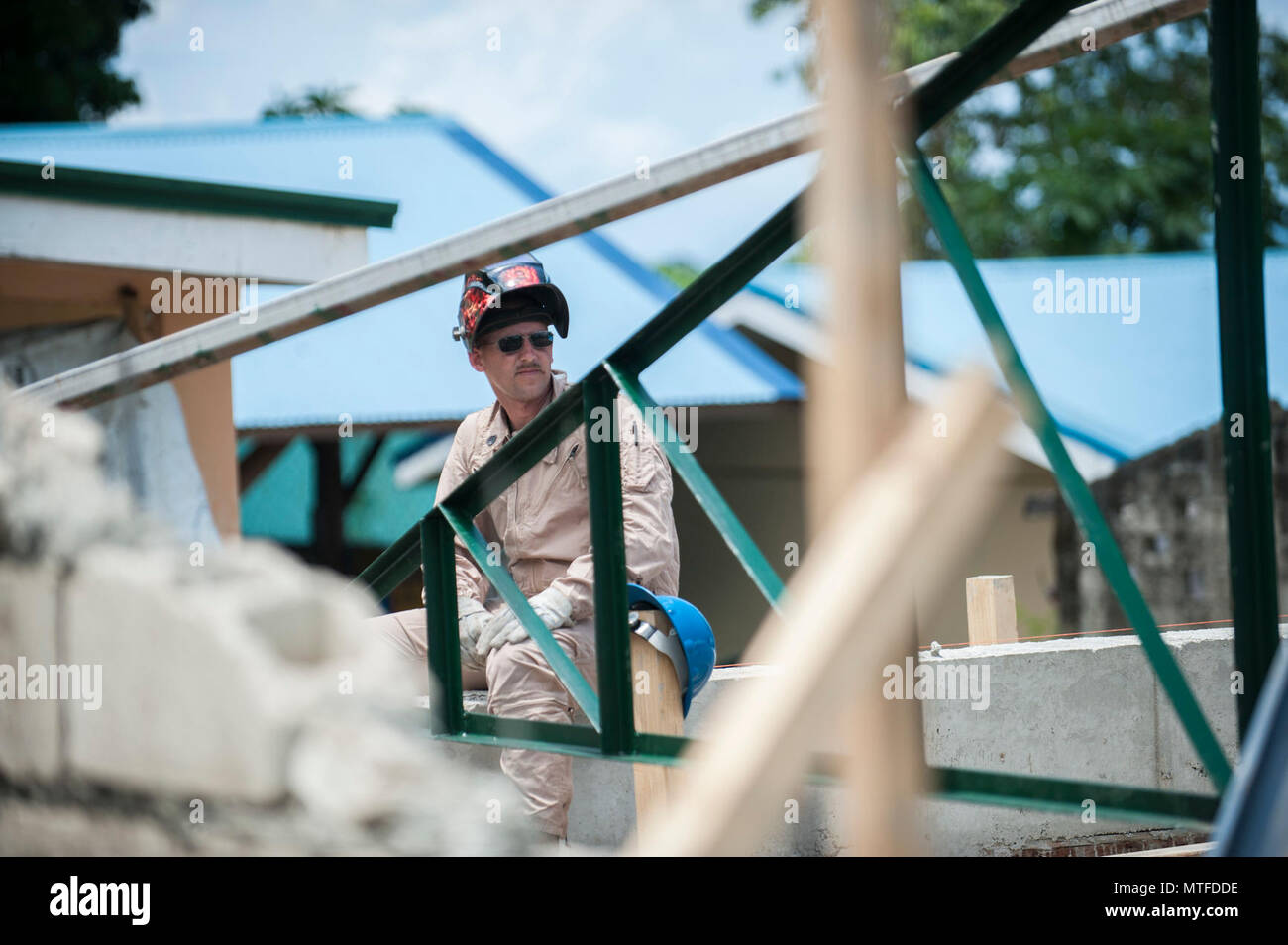 U.S. Marine Staff Sgt. Mathew Rose supervises from one of the roof ...