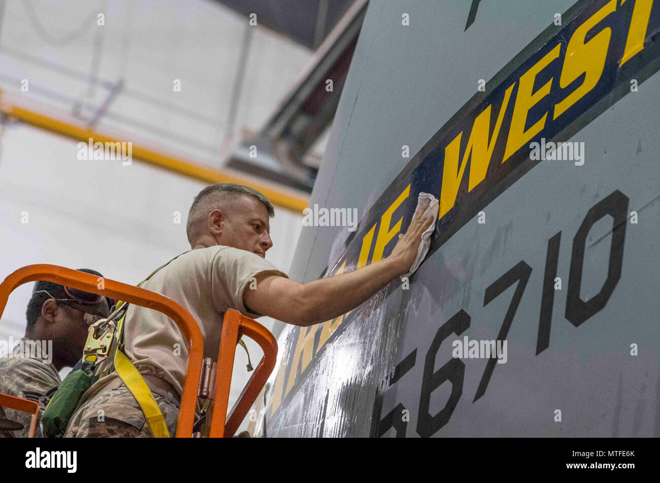 Master Sgt. William Craddock wipes down a recently placed “Charlie West ...