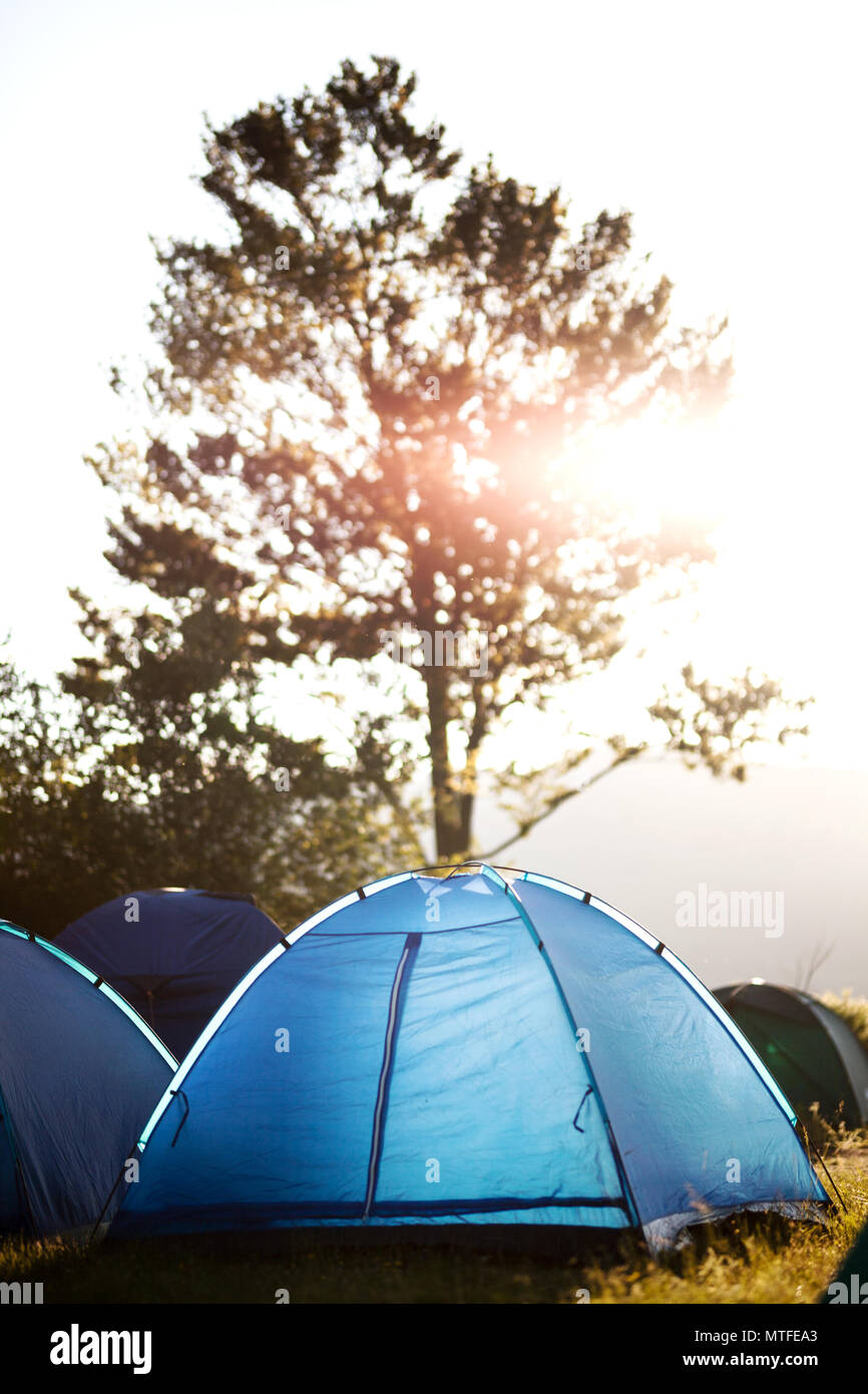 blue tent on a camping site. backlit with a sunset Stock Photo - Alamy
