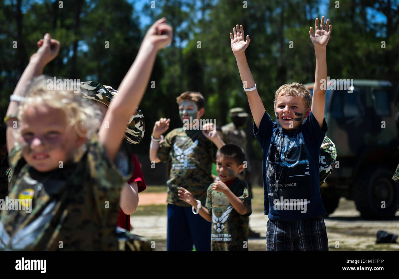 Military children participate in physical training at a deployed ...