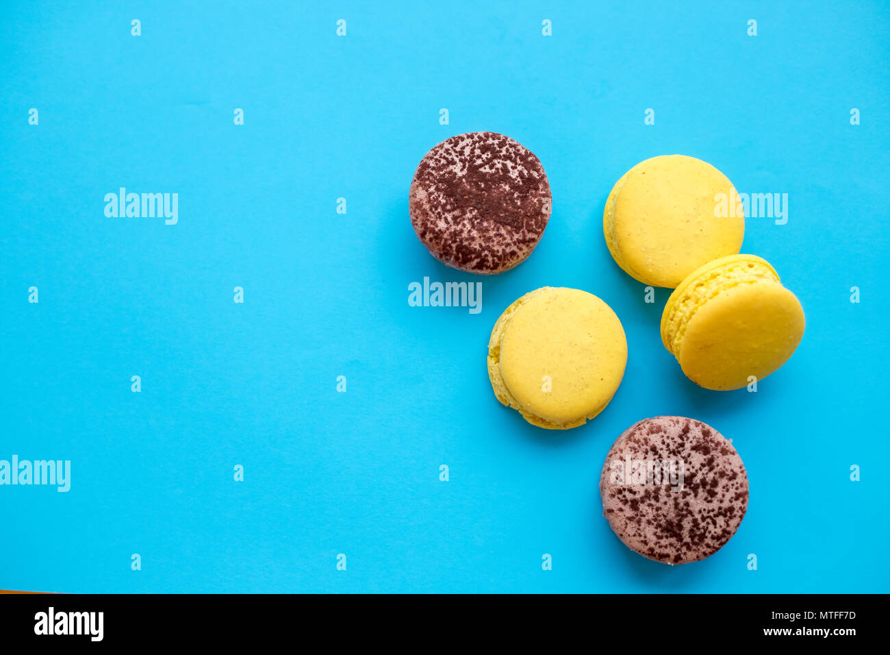 Colorful macarons cake, top view flat lay, sweet macaroon on color blue ...