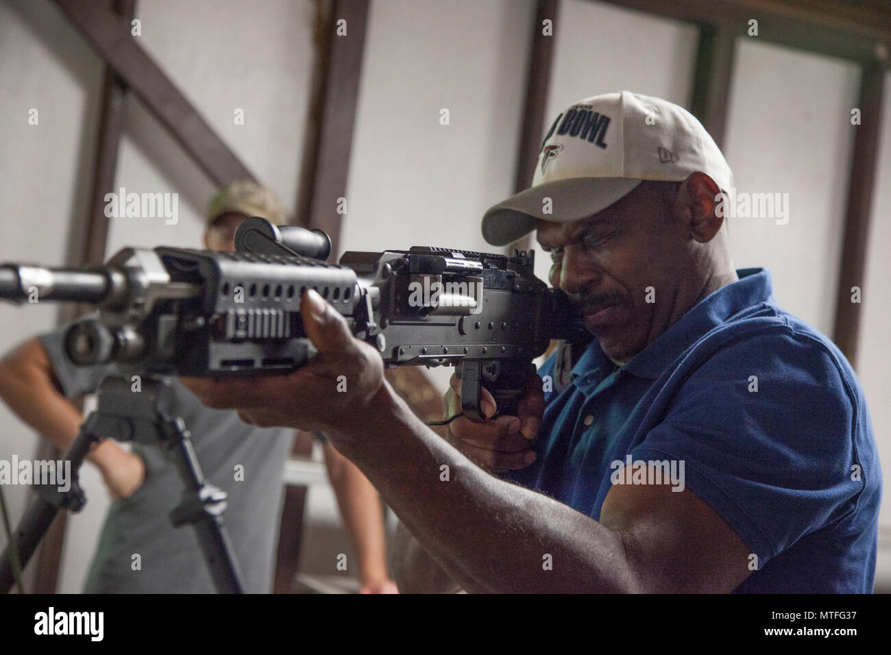 A guest holds a M240B Machine Gun at the 5th Ranger Open House 2017 on ...