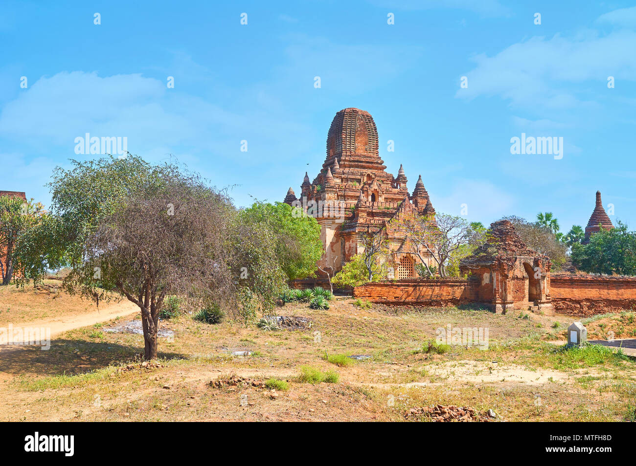 The ruins of medieval temple complex surrounded with walls in Bagan ...