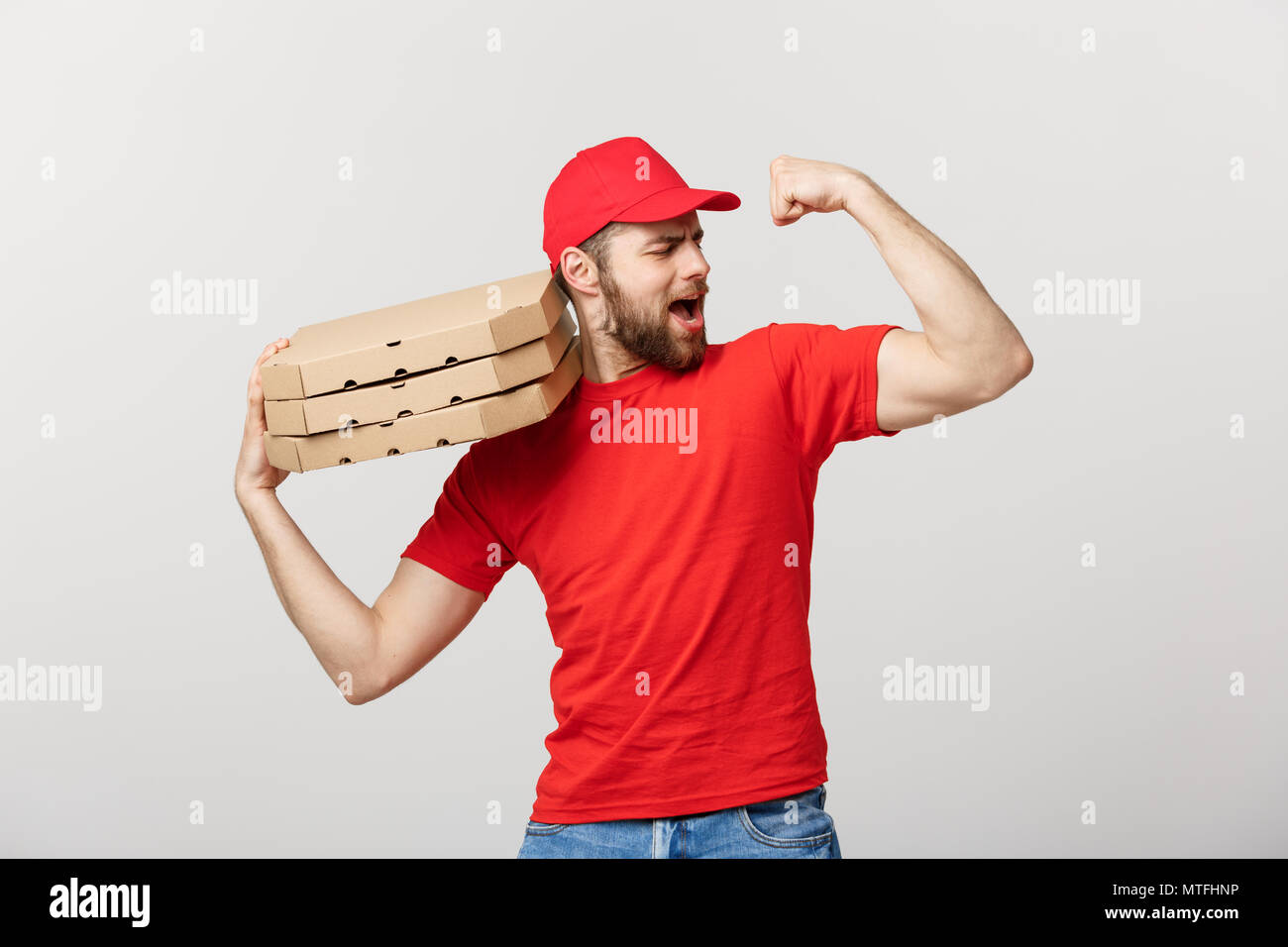 Delivery Concept - Portrait of Strong handsome delivery man flexing his ...