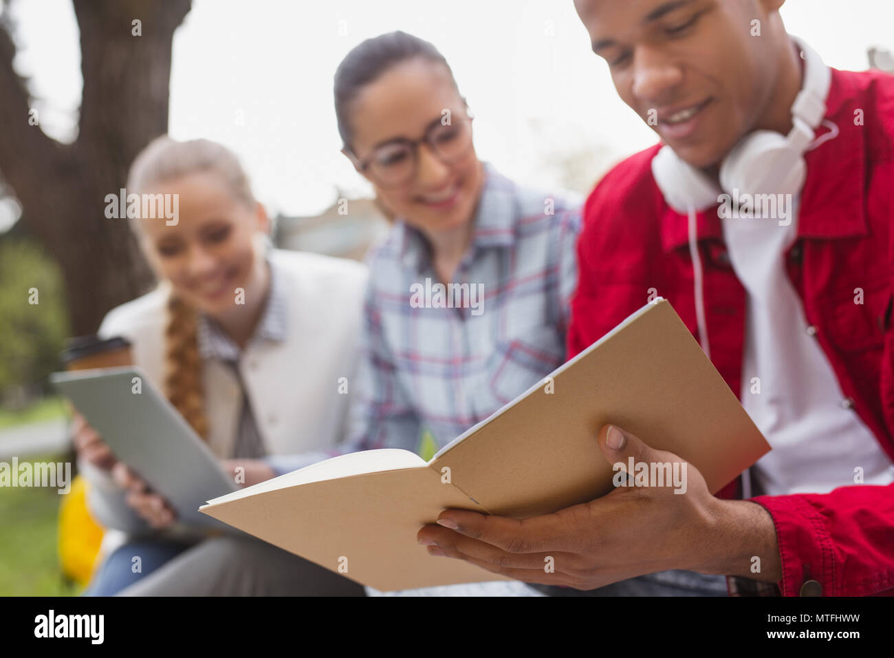 Diligent student holding his notebook in hands Stock Photo - Alamy