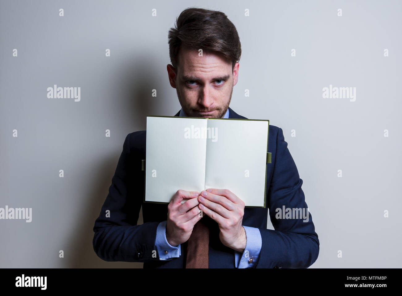 Angry business man showing blank note. Studio portrait isolated Stock ...