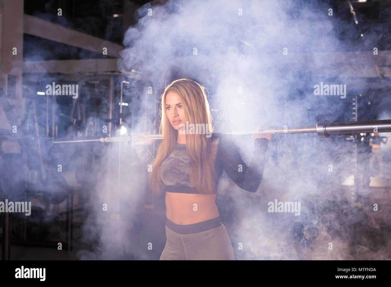Pretty working out with barbell in a gym Stock Photo - Alamy