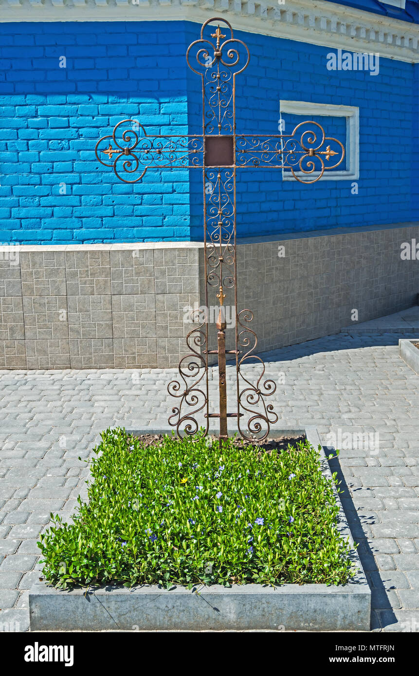 Tomb cross in front of cemetery church hi-res stock photography and ...
