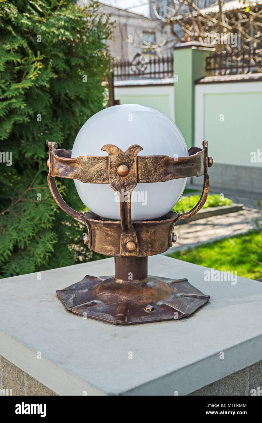 A spherical street lamp in a forged garment which is installed near the ...