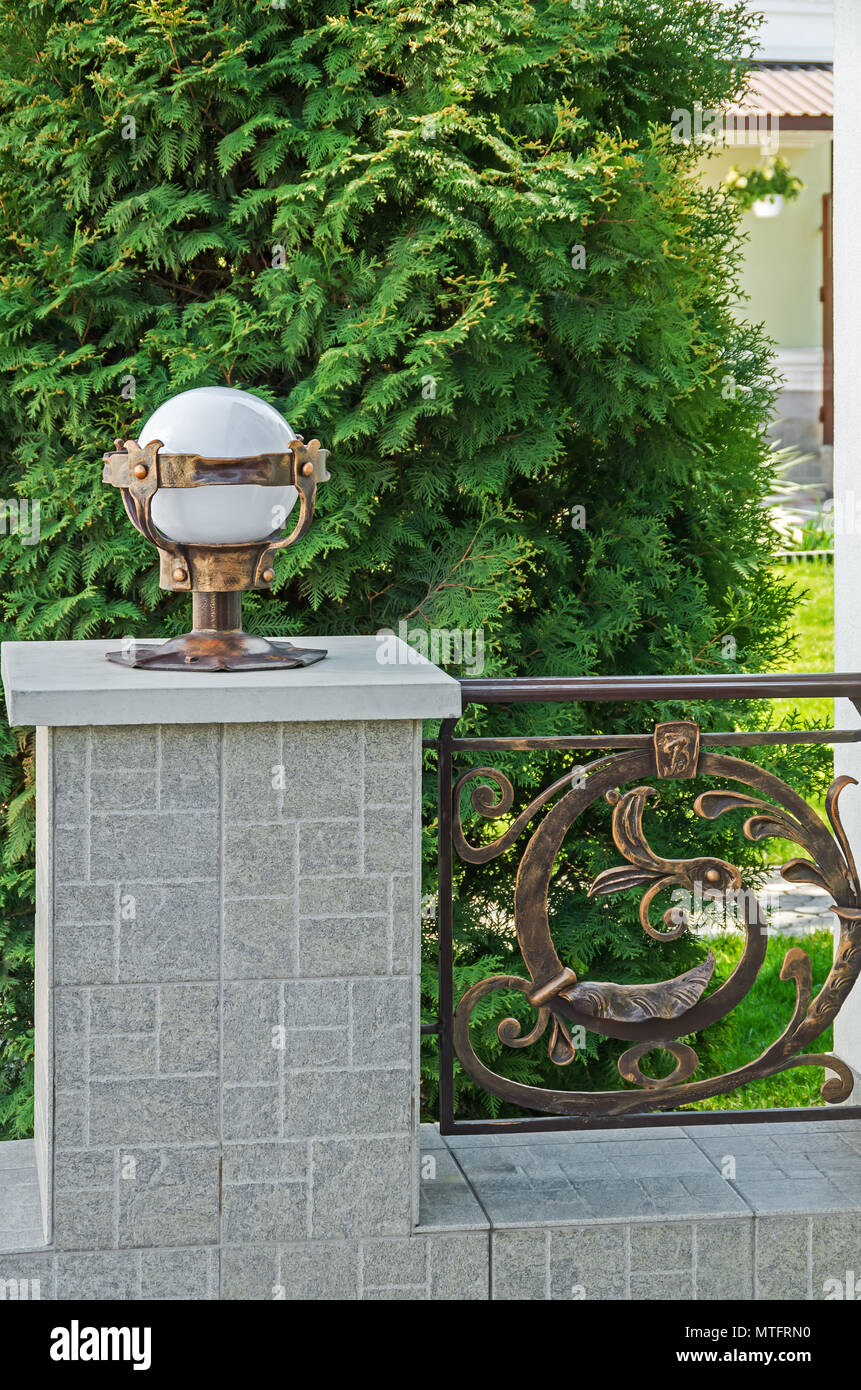 A spherical street lamp and forged railing which is installed near the ...